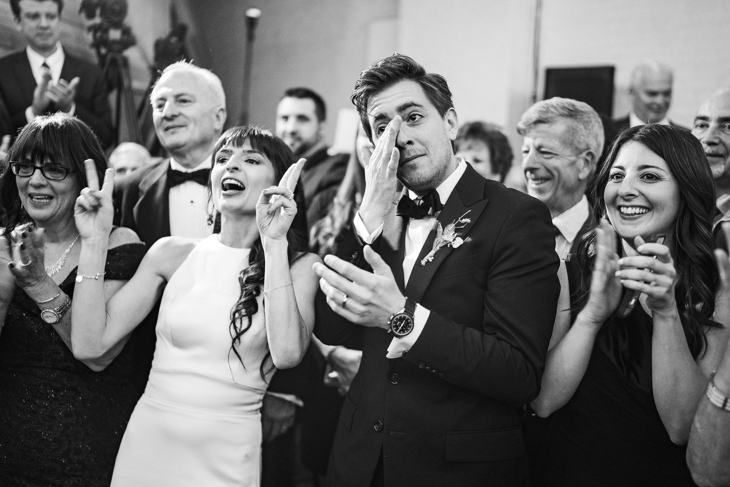 Guests with strong emotion both clapping and wiping tears - photo by ...