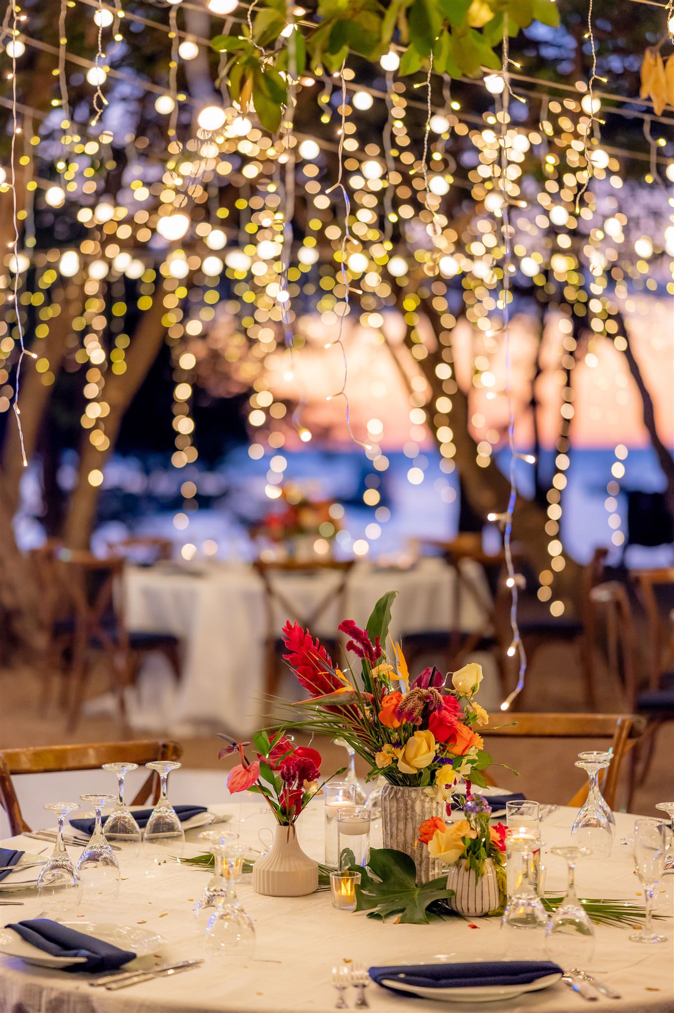Outdoor reception tables with hanging lights - photo by Kevin Heslin ...