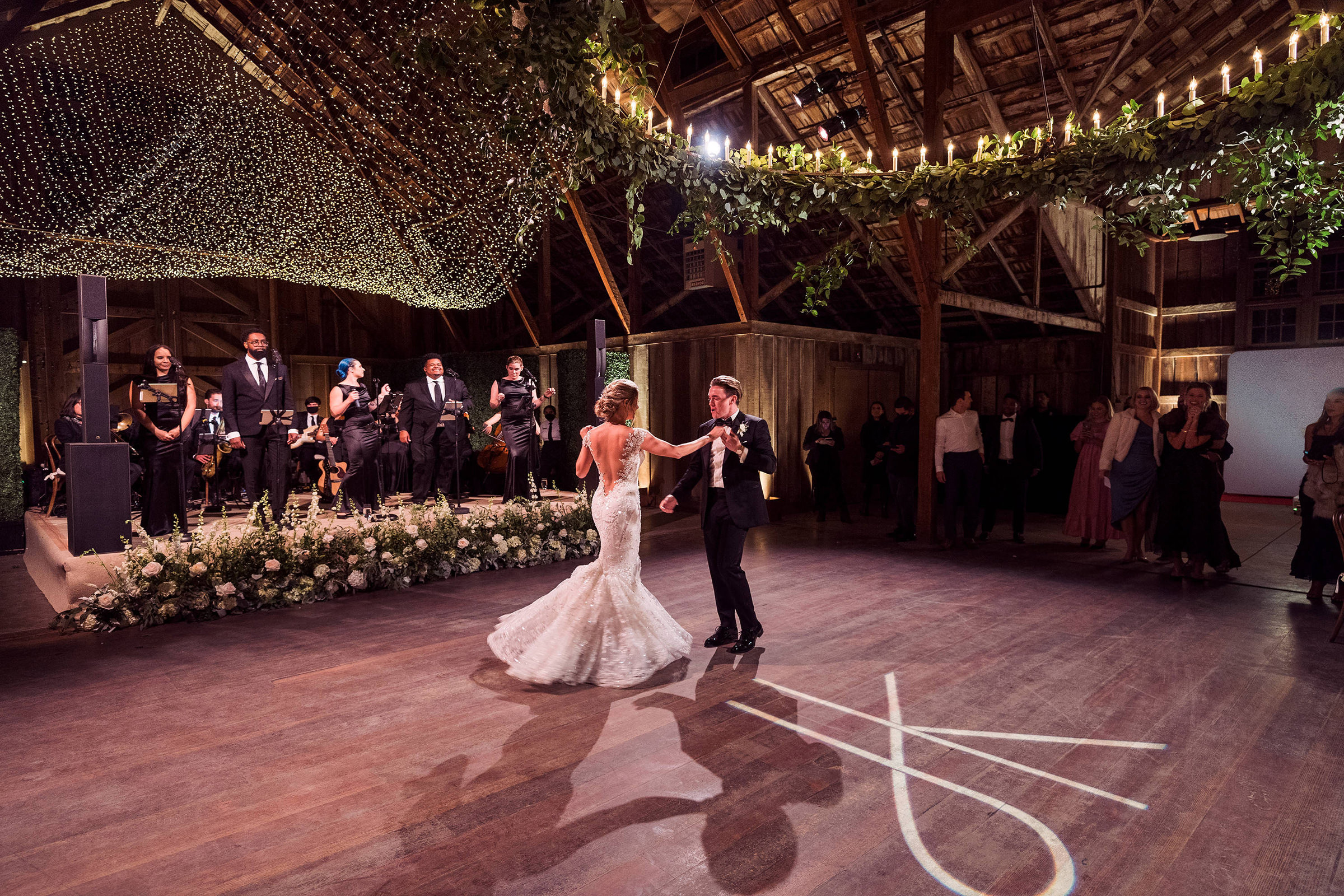 Elegant first dance in rustic interior setting - photo by John & Joseph