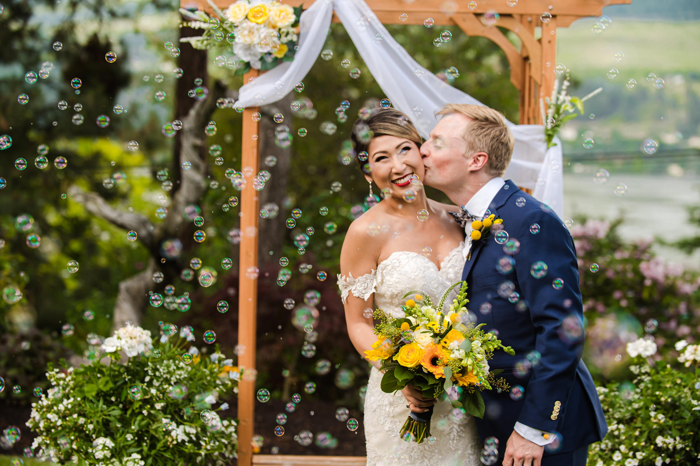Enthusiastic kiss for the bride with floating bubbles - photo by David ...
