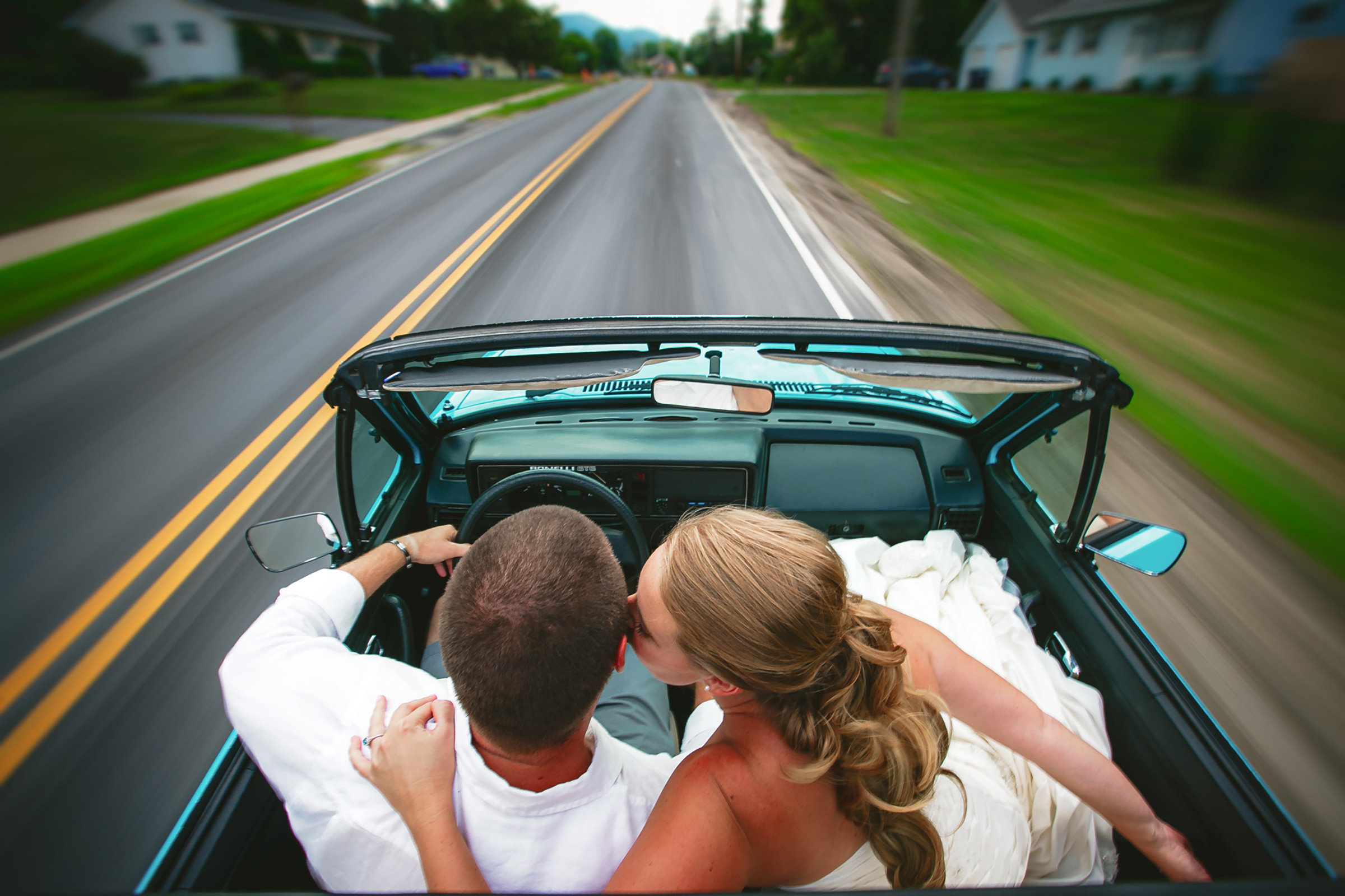 Aerial view of couple zooming down road - photo by Garrentee Photography
