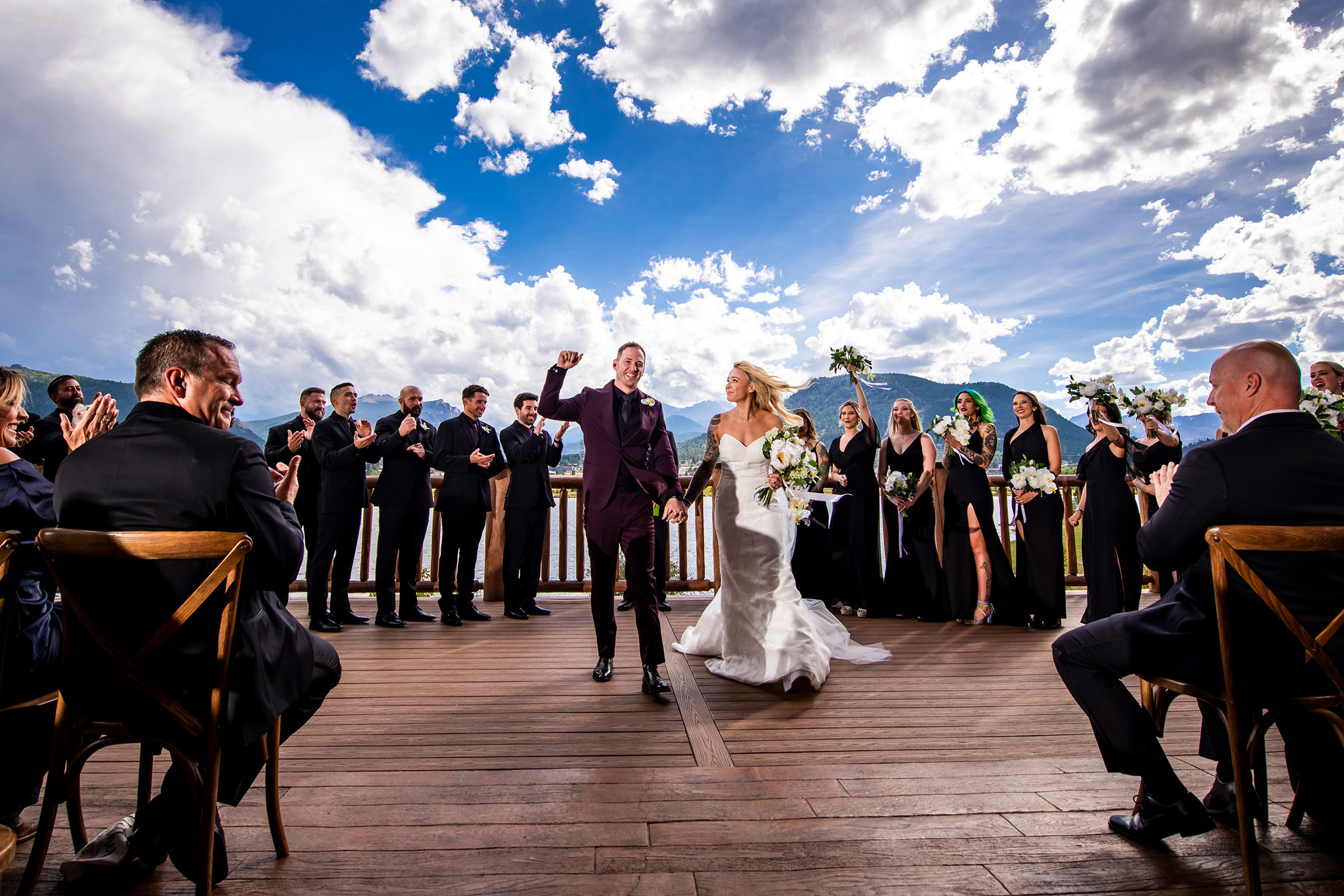 Couple recessional on deck under blue sky - photo by J. La Plante Photo