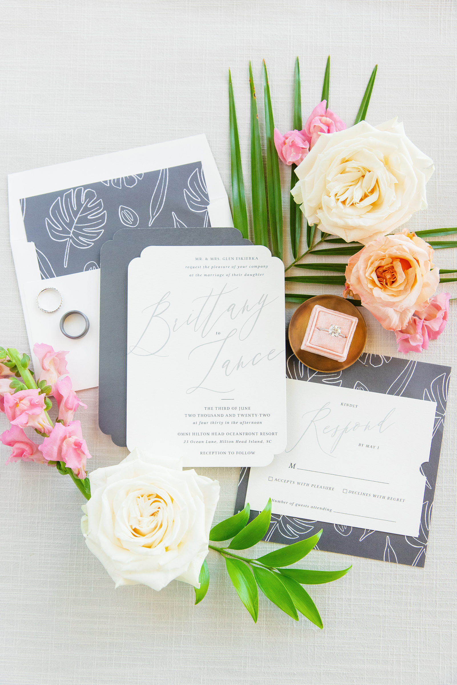 Flat lay with invitations, rings, and flowers - photo by Dana Cubbage ...