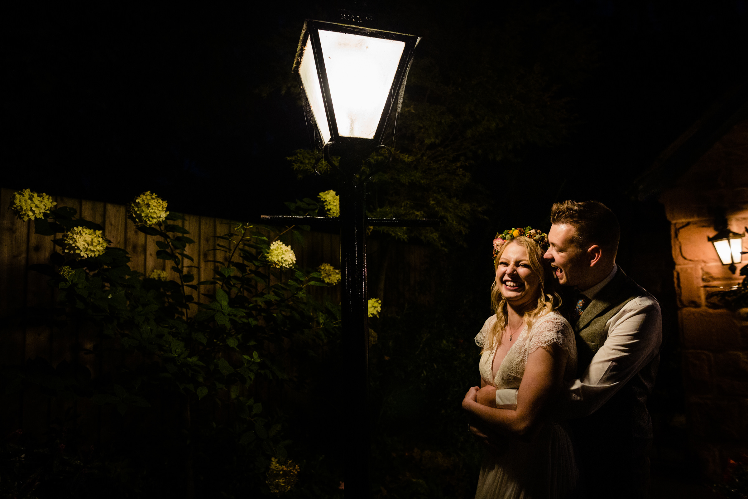 Happy couple hug at night - photo by Emma + Rich