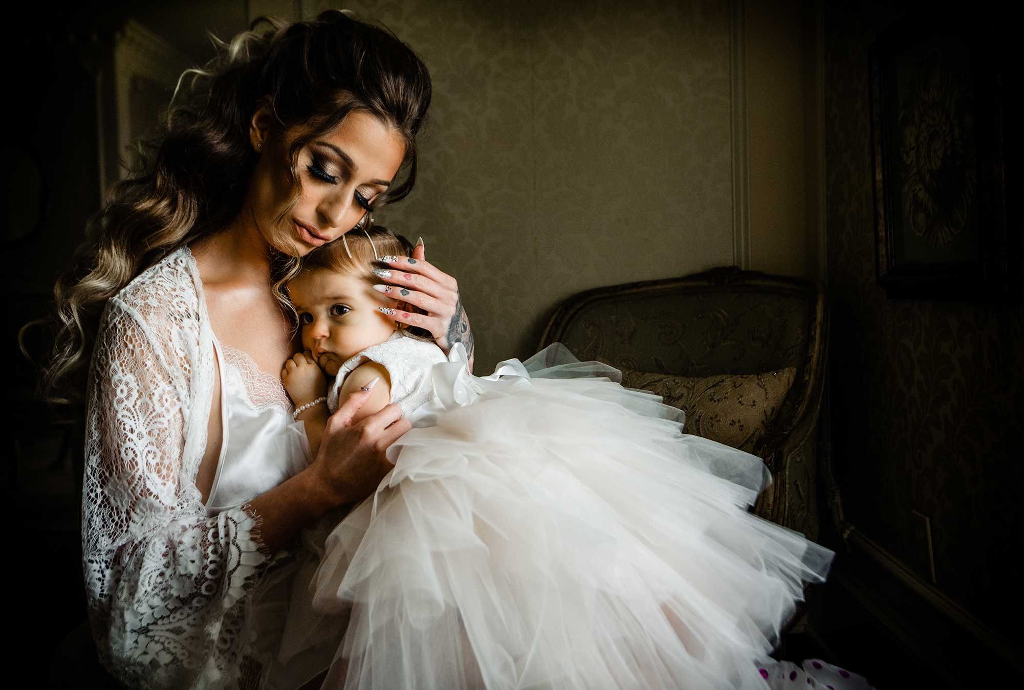 Bride holding baby in dressy clothes - photo by Jeff Tisman Photography