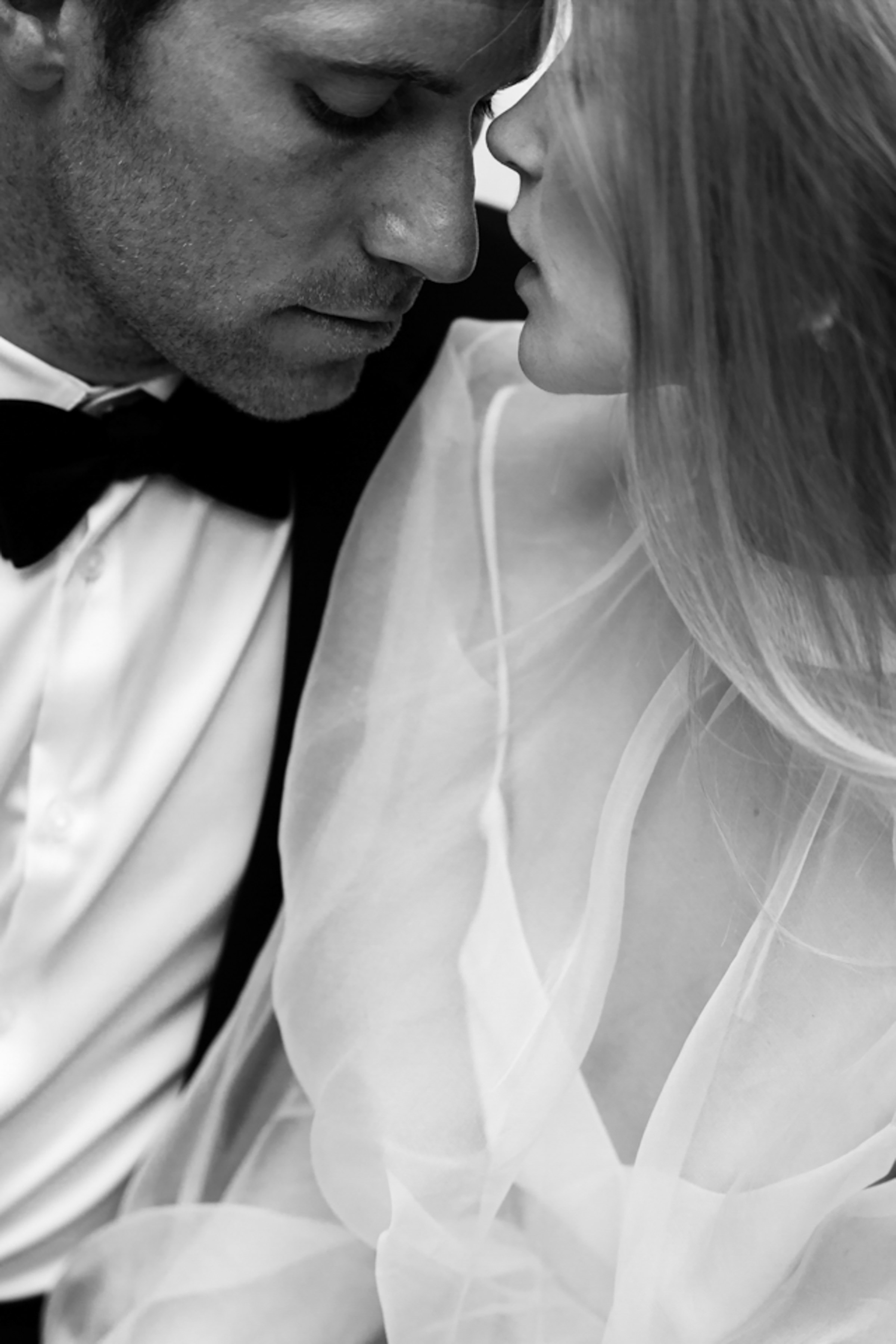 Cropped whispering couple - photo by Marion Co