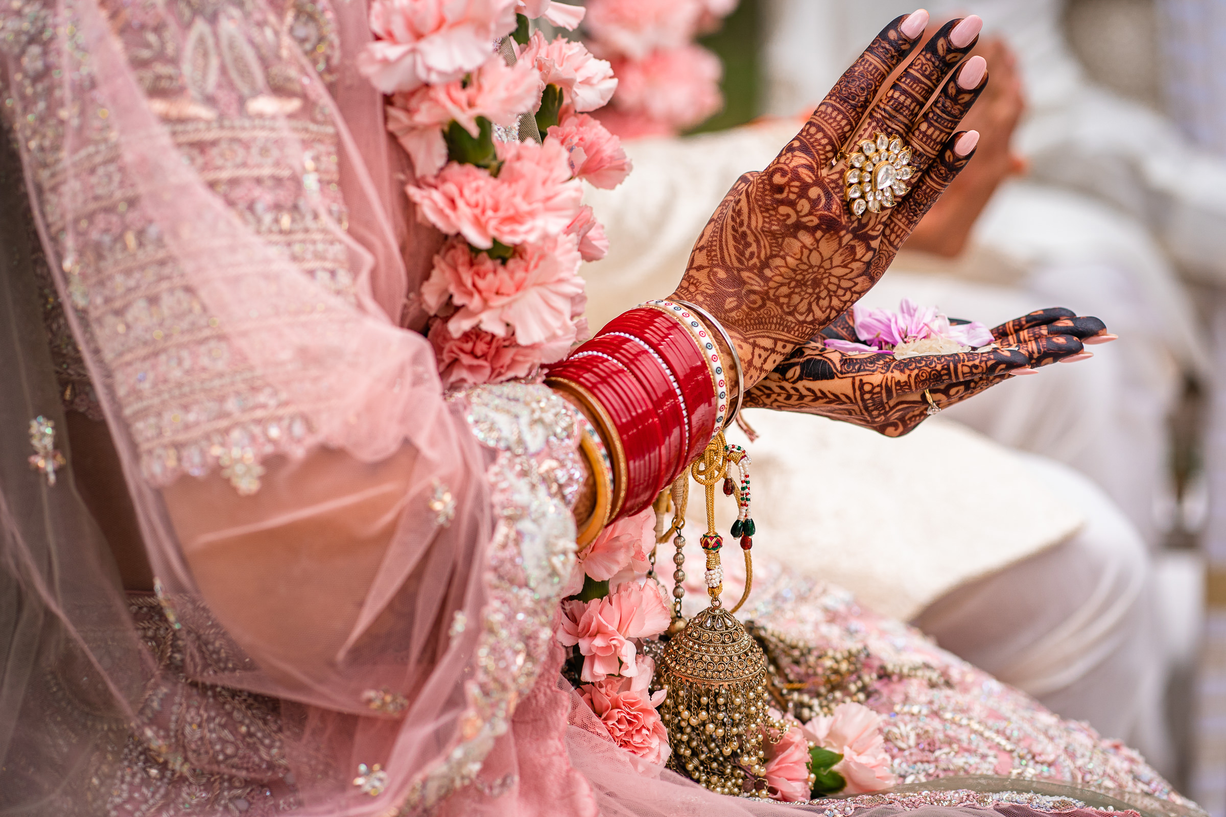 Cropped bride in pink with henna hands, photo by Phil Salisbury Photography