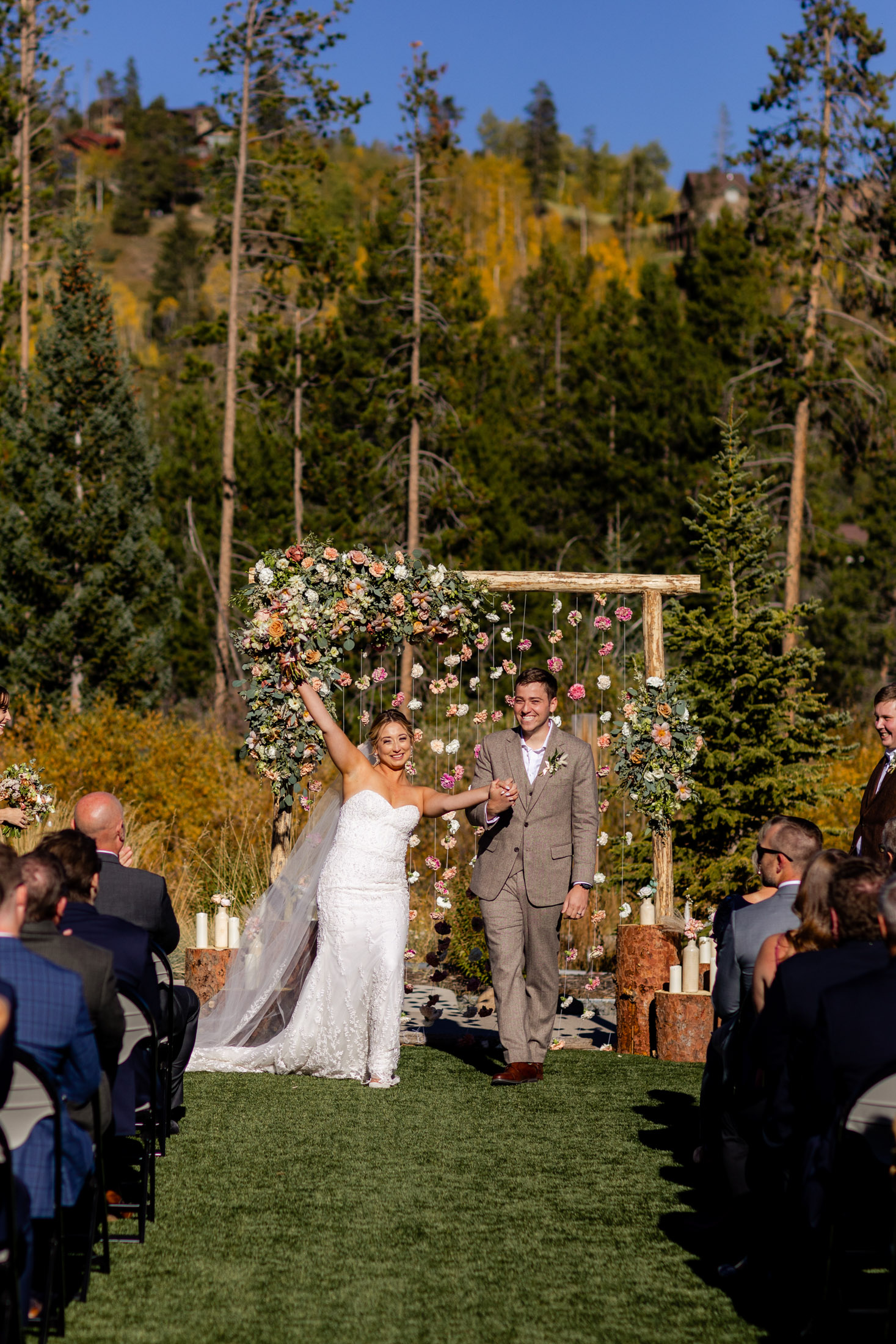 Just married happy couple at floral arbor in natural setting, photo by ...