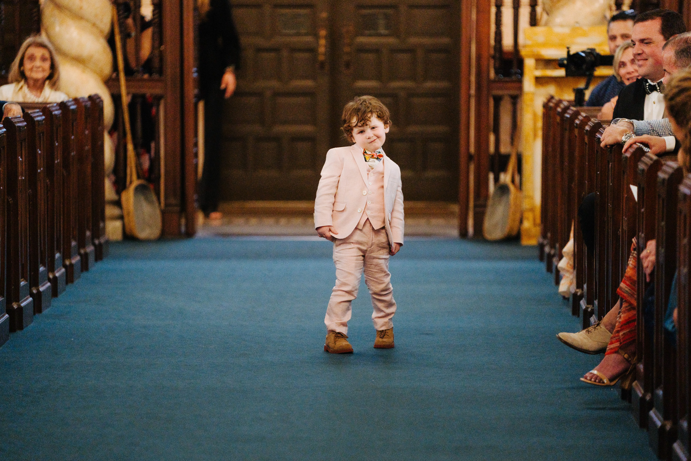 Cute little boy in church aisle, photo by Love Life Images