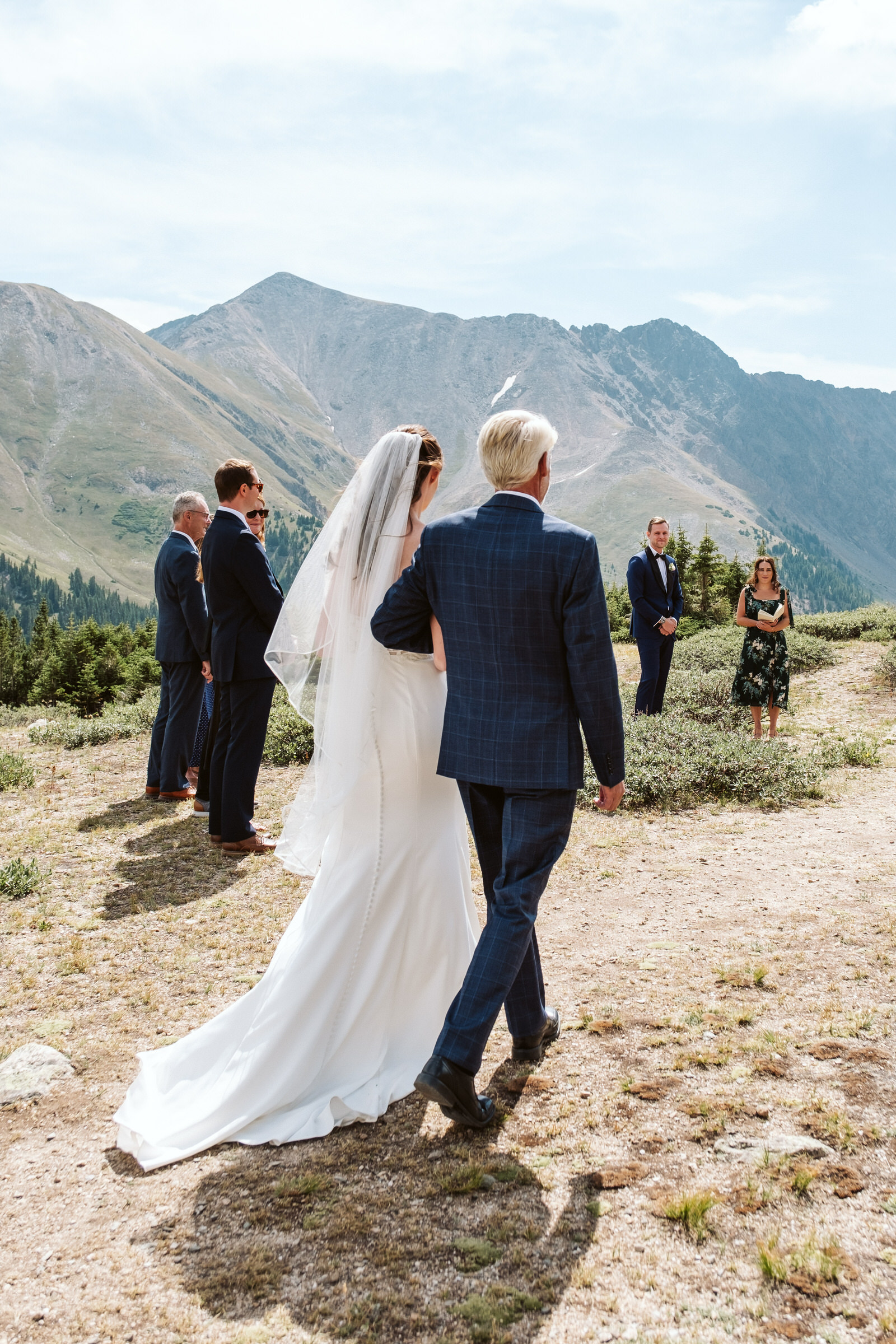 Father walking bride down natural outdoor aisle at ceremony, photo by Larsen Photo Co.