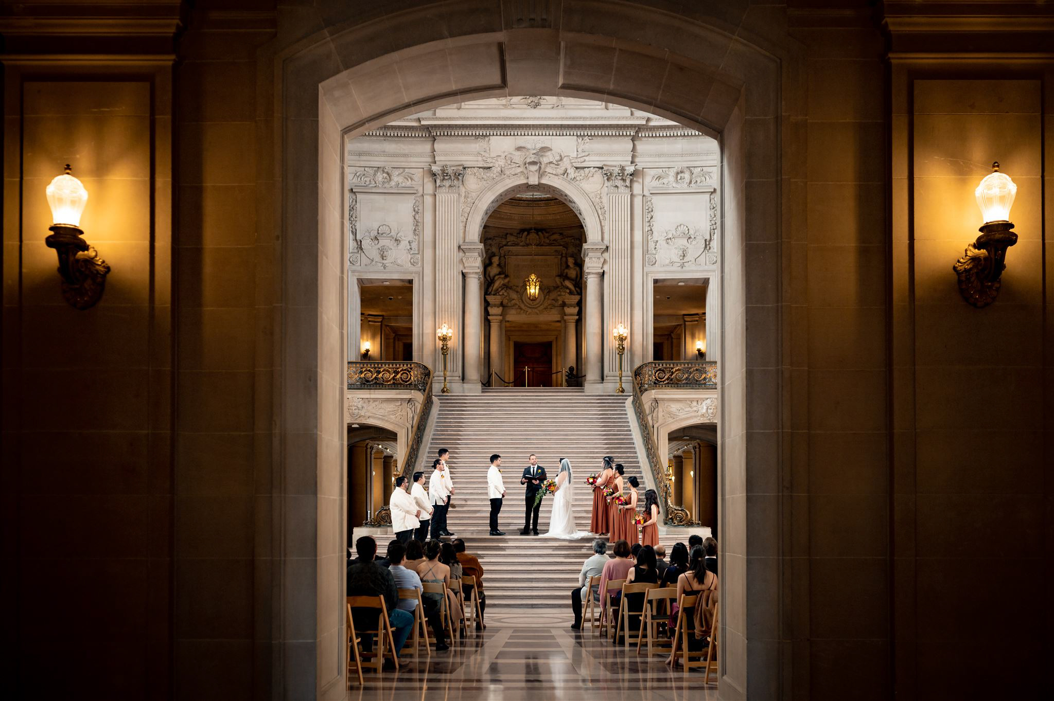 Ceremony on grand stairway seen through doorway, photo by Lisa Stone ...