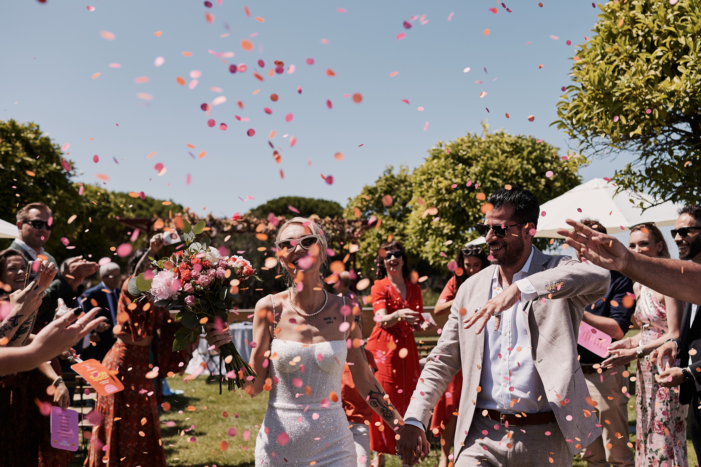 Outdoor couple recessional to shower of rose petals, photo by Nuno Lima ...