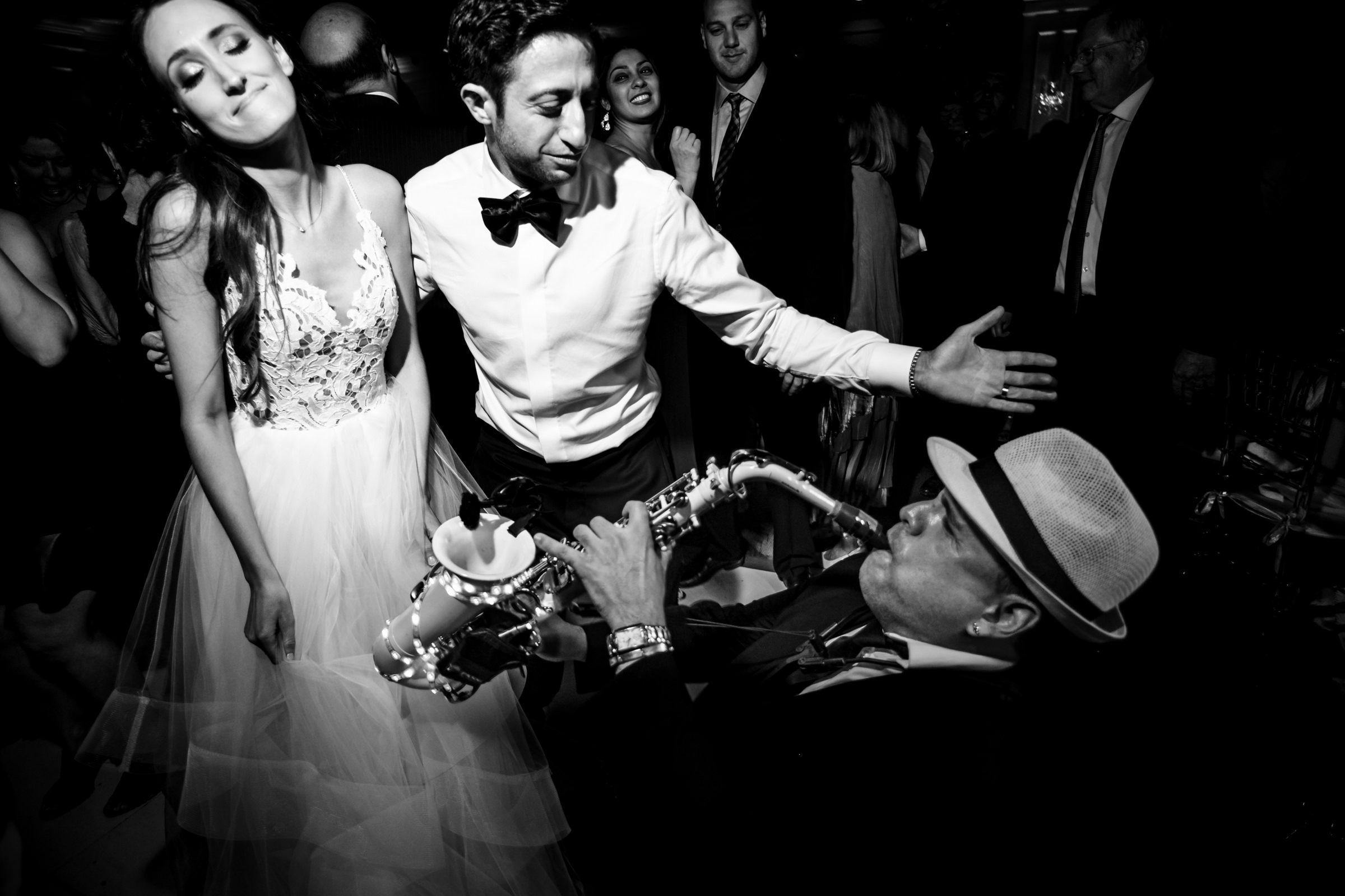 Cinematic black and white of couple with sax player - photo by Michael ...