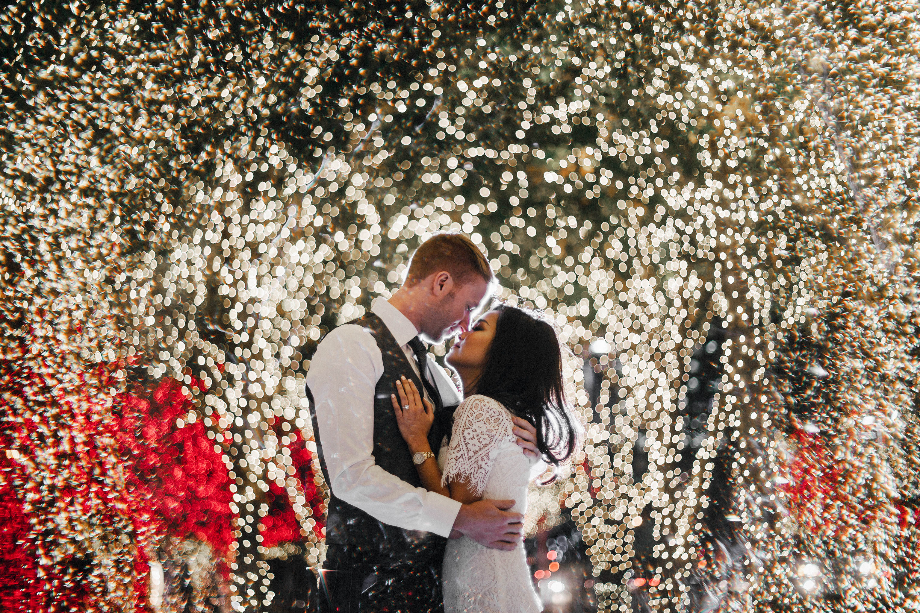 Bokeh couple embrace - photo by Daniel Colvin Photography